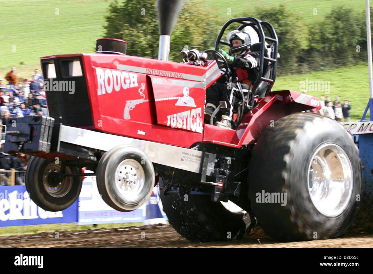 This stock photo shows a high-speed tractor racing across an open field ...