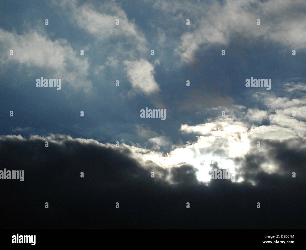 This image shows a sky filled with rain clouds, with dark, heavy clouds ...
