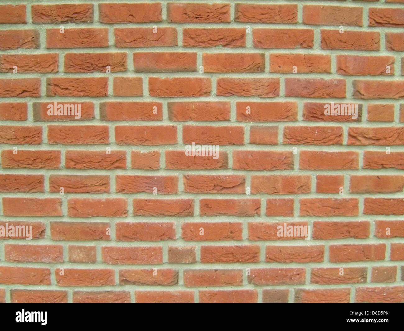 A red brick wall, a classic material used in home construction ...