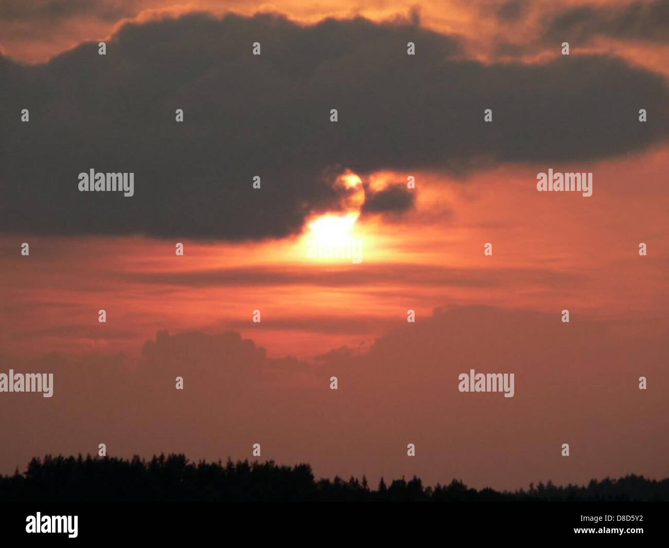 A breathtaking red sunset is captured over the horizon. The sky is ...