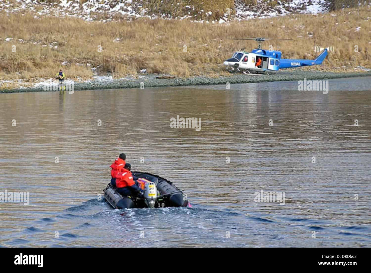 A rescue operation in progress, featuring a rescue boat and helicopter ...