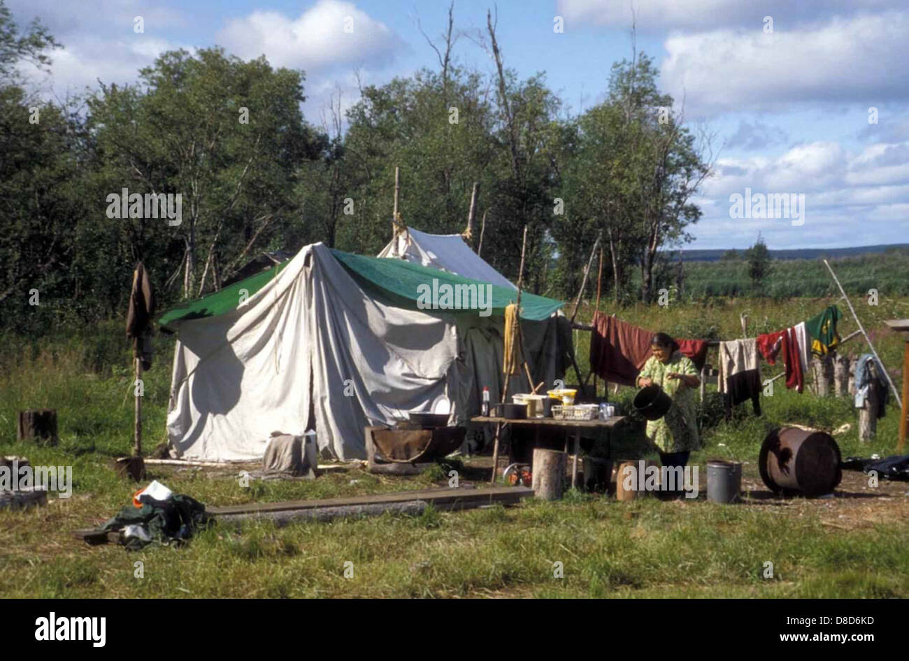 A river fish camp is set up along the banks of a river, with equipment ...
