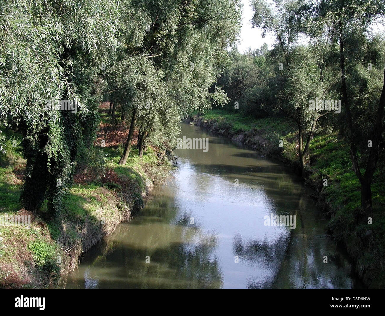 This image shows a scenic river landscape, with flowing water ...