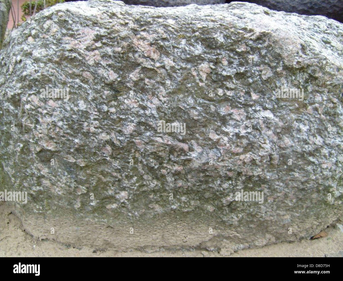 A natural rock formation with various textures and colors. The image ...