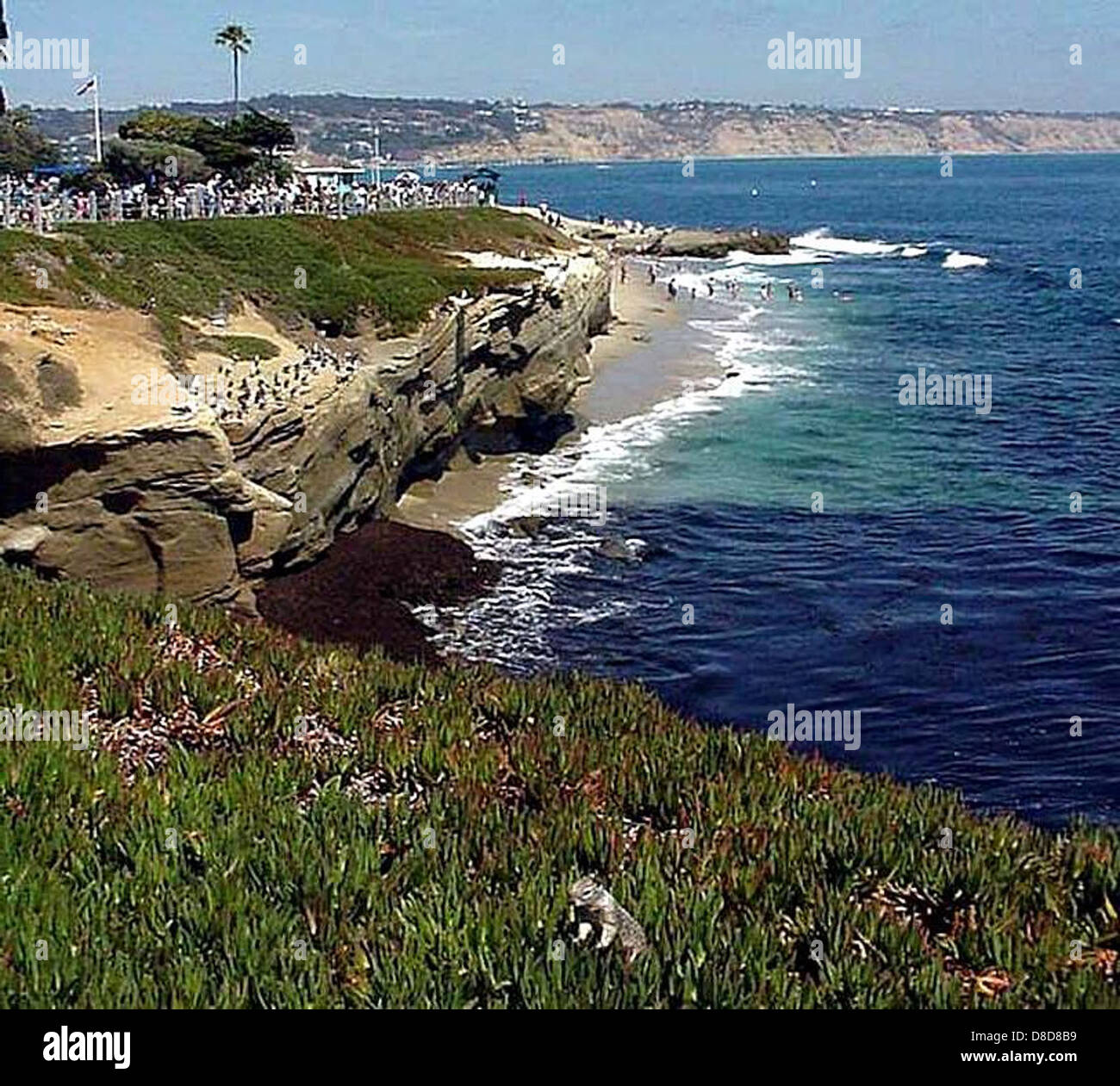 A coastal landscape featuring the sea meeting the shoreline, with waves ...