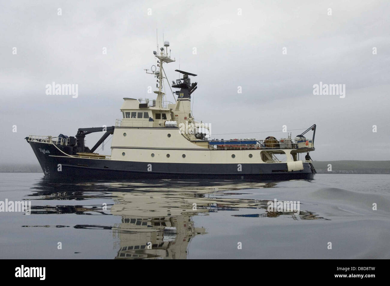 This image shows a ship sailing on calm waters, likely during a ...