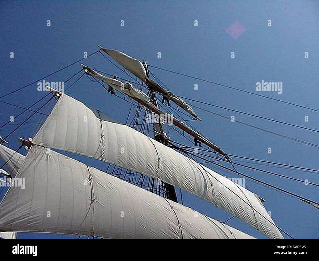 A ship with sails glides across the water, showcasing the traditional ...