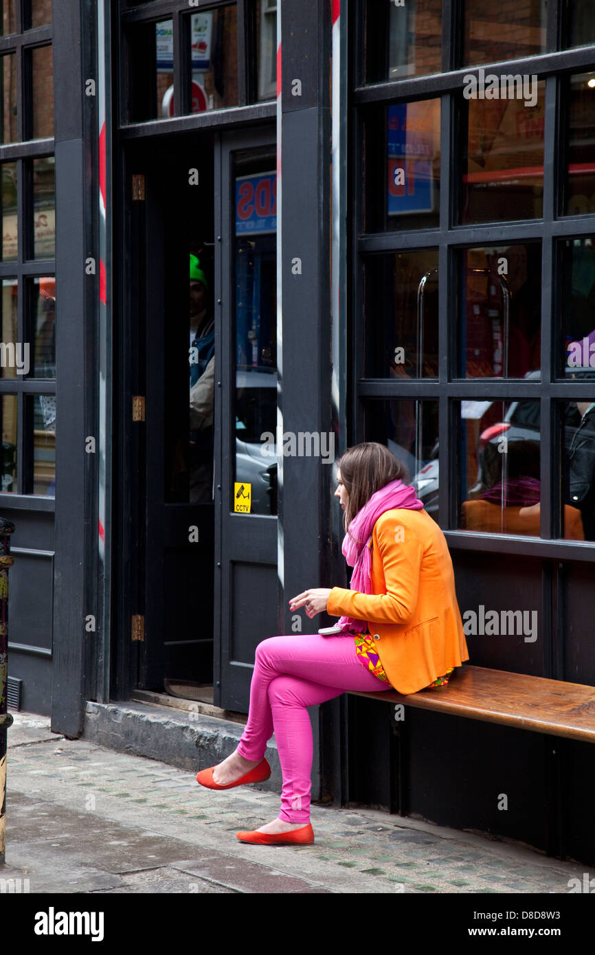 Woman sitting outside a shop, Brick Lane, London, England Stock Photo ...