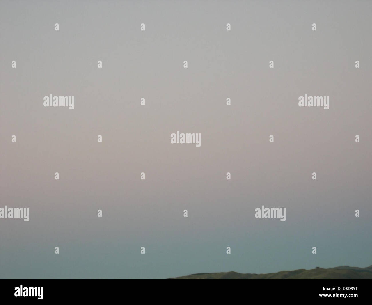 A beautiful gradient sky transitions from soft hues of orange to deep ...