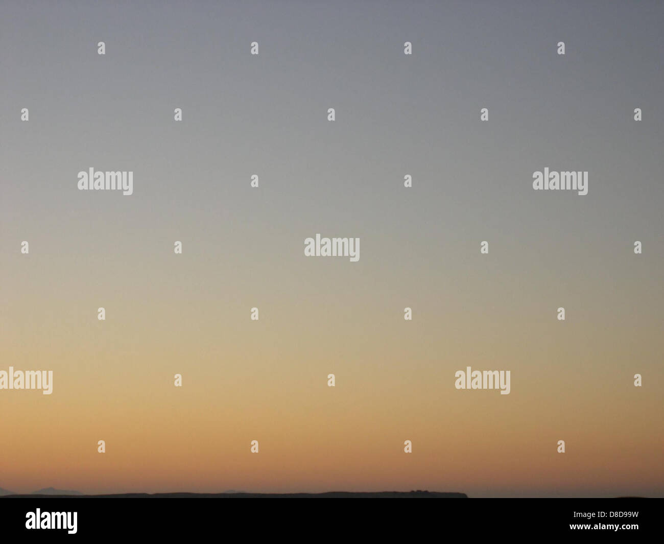 A beautiful gradient of colors fills the sky at dusk, transitioning ...