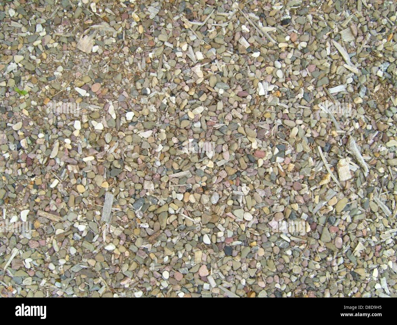 A close-up of small pebbles with a rough texture, often used in ...