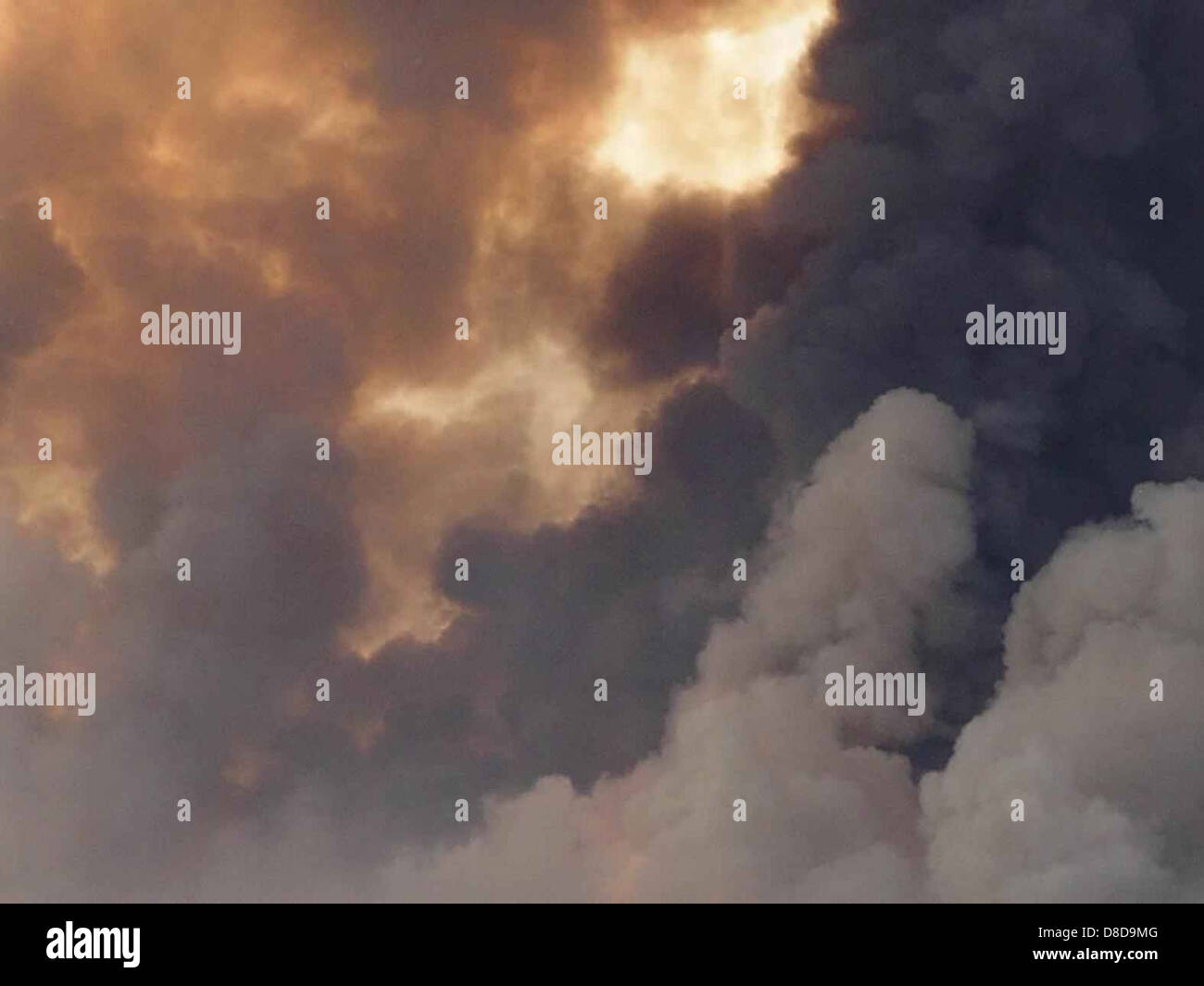 Columns of smoke rise into the sky, often seen from wildfires or ...