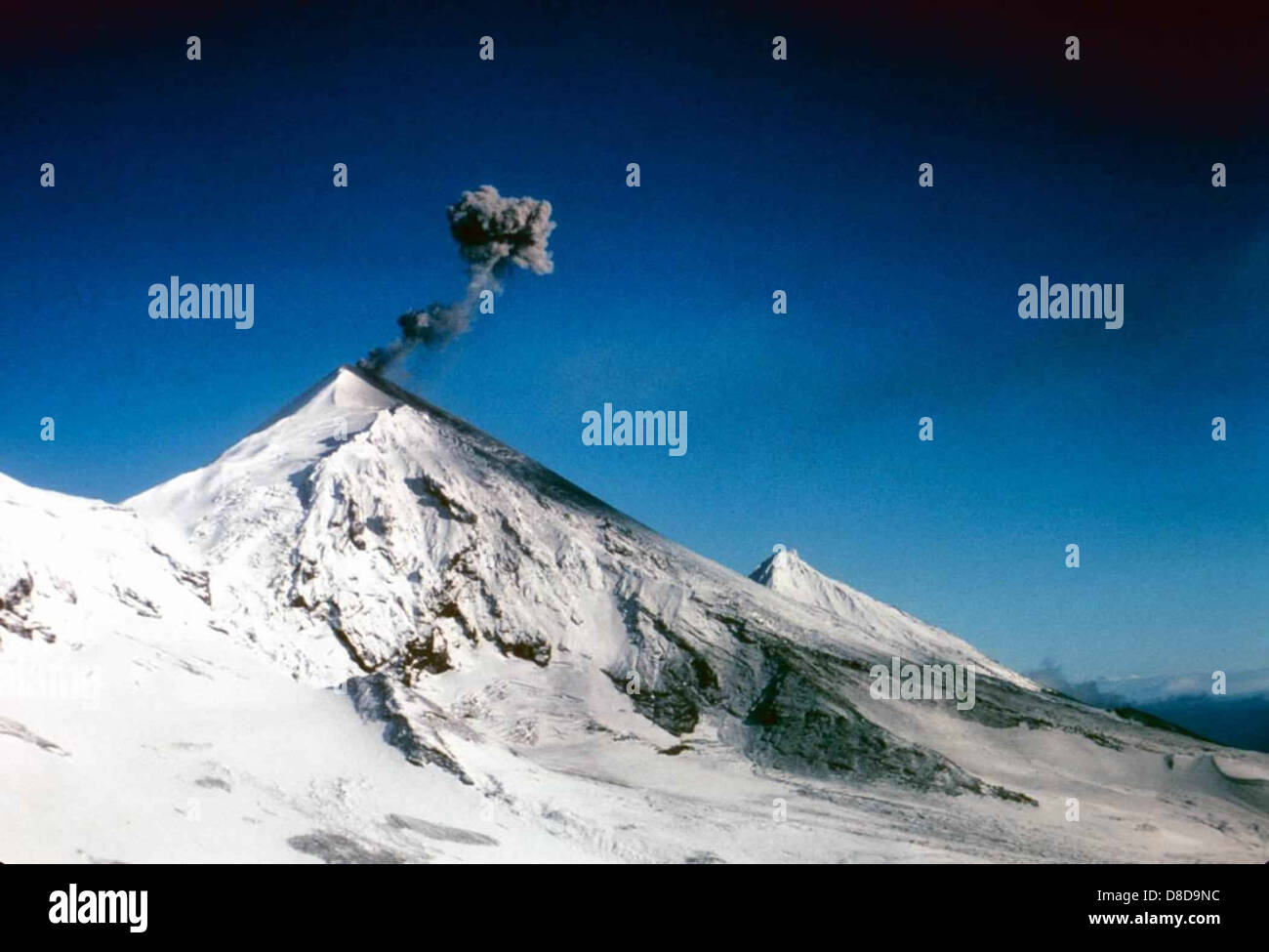 Smoke rises from an active volcano, showing the power and intensity of ...