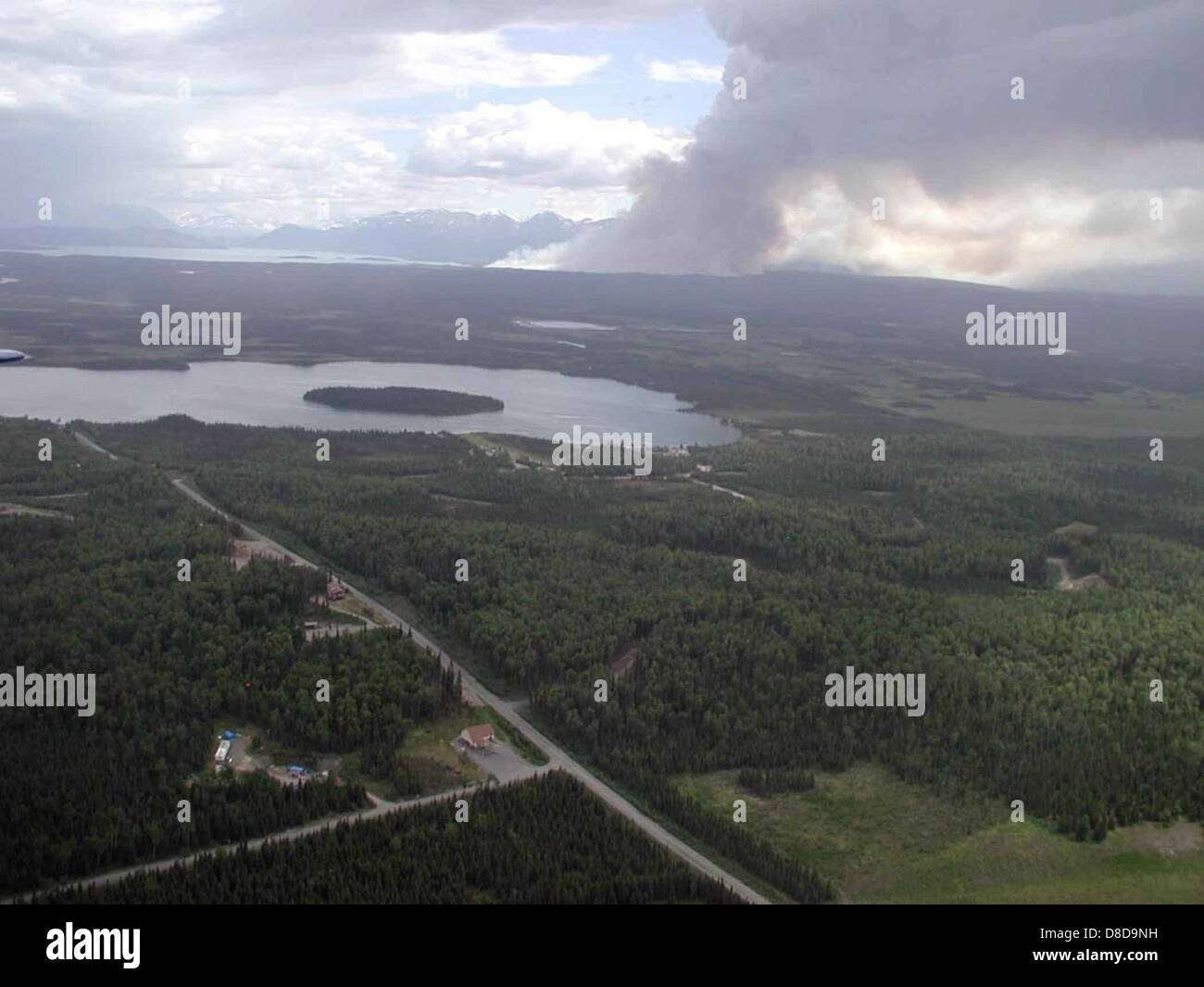 Smoke rising from a wildland area near an urban setting, depicting the ...