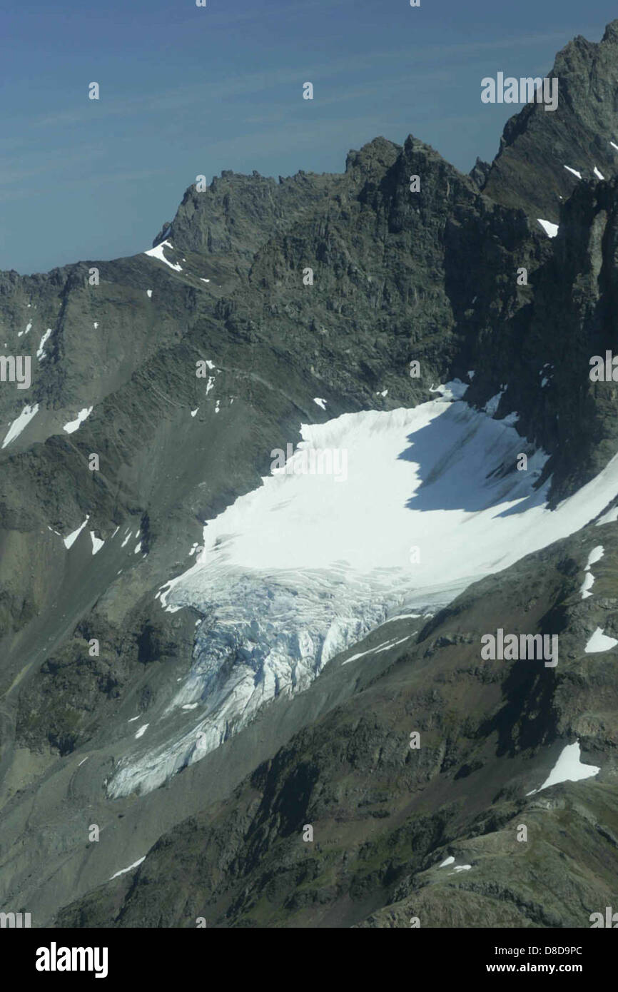 A snowslide cascades down the steep mountain peaks, showcasing the ...