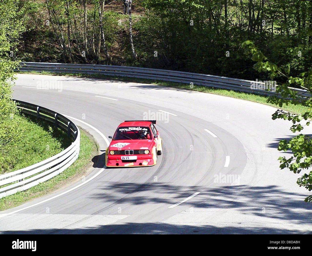 This image captures a sport car participating in a race, showcasing the ...