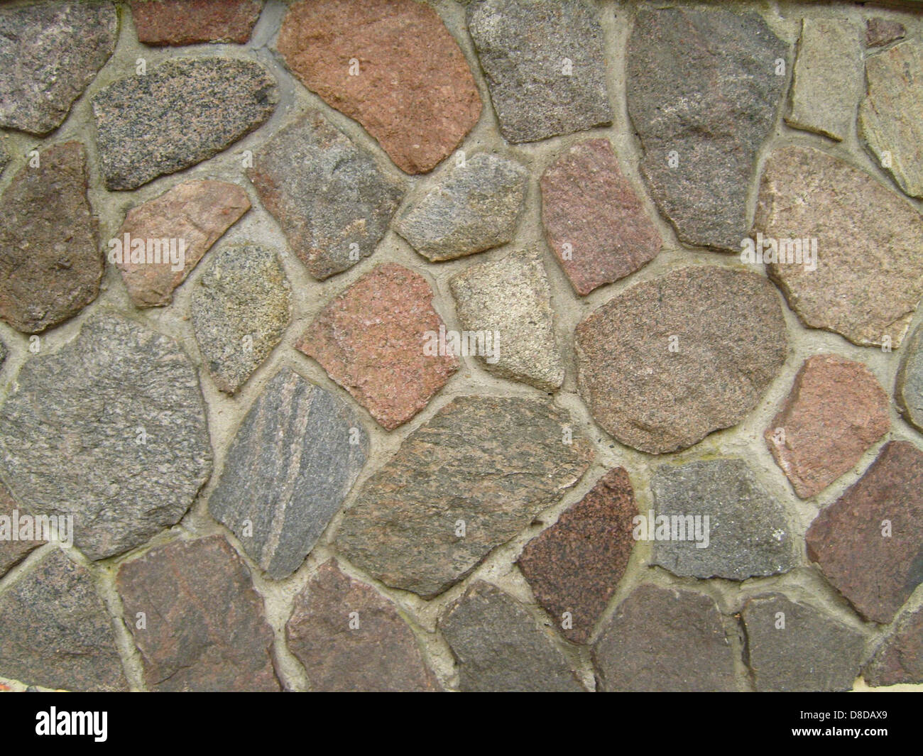 A stone-paved pathway winding through an outdoor area, made up of ...