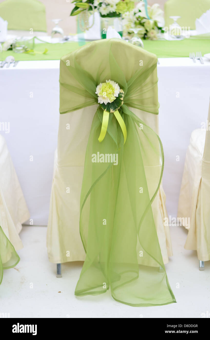 Wedding chair decorated with green color and flower Stock Photo - Alamy