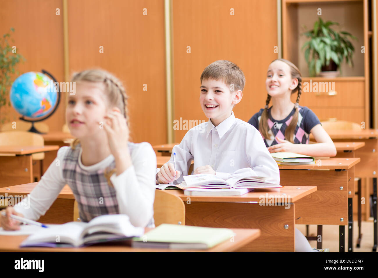 schoolchildren at lesson in classroom Stock Photo - Alamy