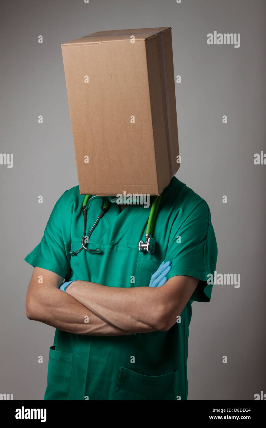 Doctor with cardboard box head in green uniform Stock Photo - Alamy