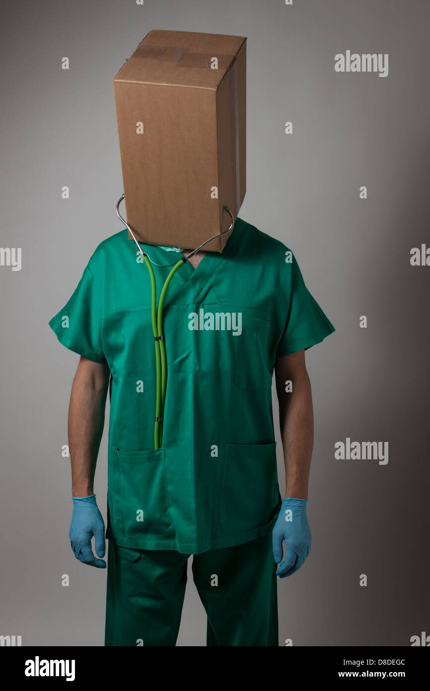 Doctor with cardboard box head in green uniform Stock Photo - Alamy