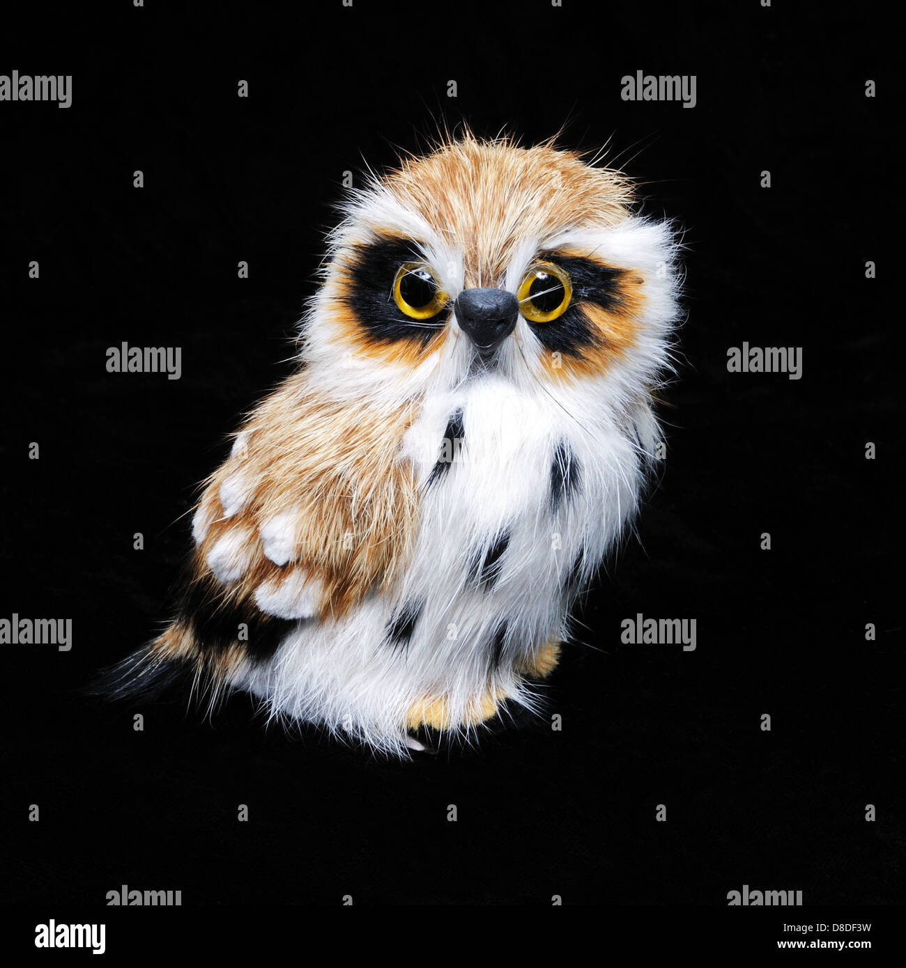 Owl standing ornament made from real fur against a black background ...
