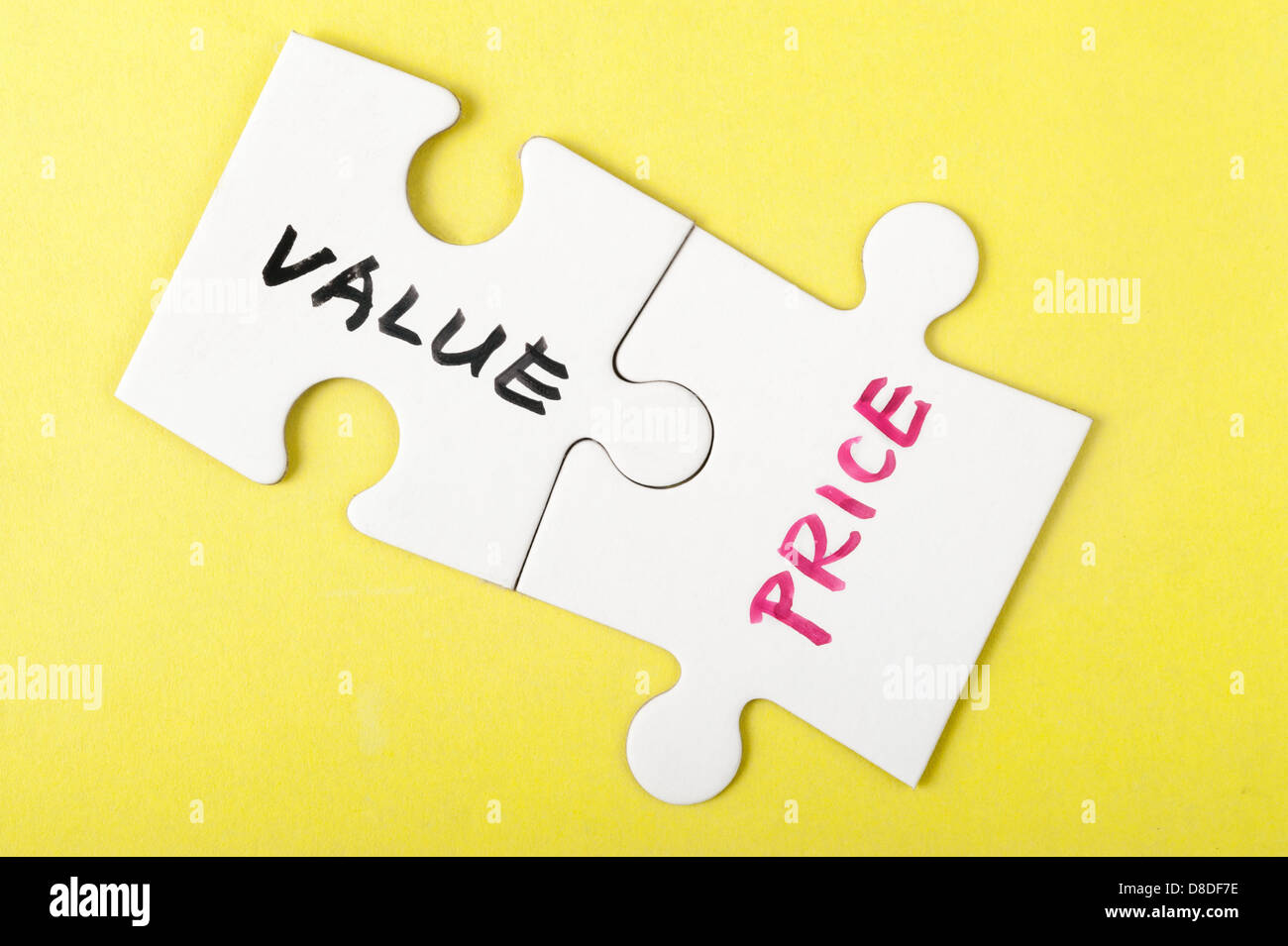 Value and price words written on two pieces of jigsaw puzzle Stock ...