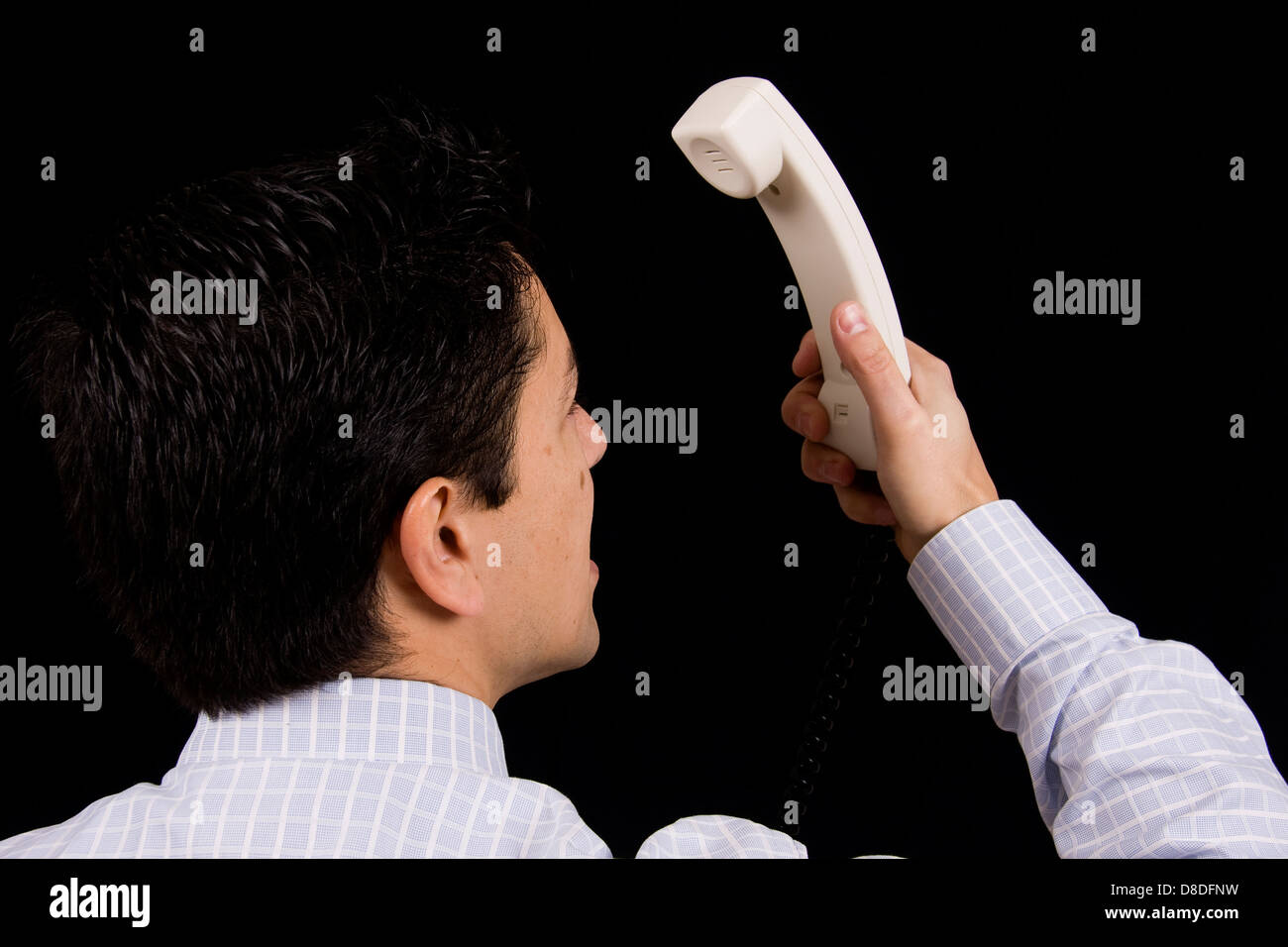 Men holding a telephone receiver isolated on black Stock Photo - Alamy