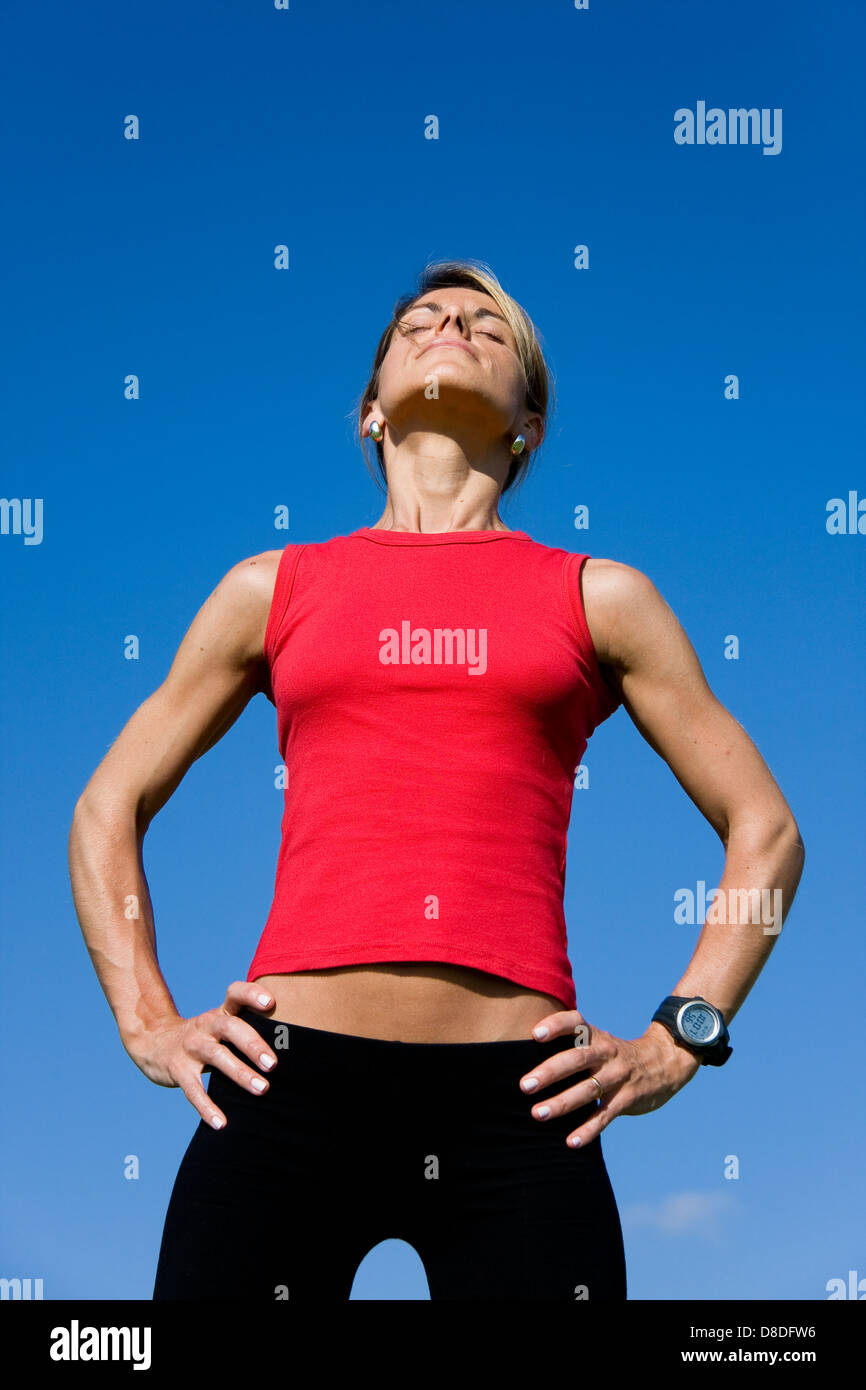 Beautiful women enjoying sun isolated on a blue sky Stock Photo - Alamy