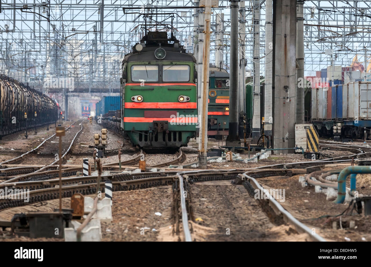 Railroad scene with bright locomotive and cargo trains Stock Photo - Alamy