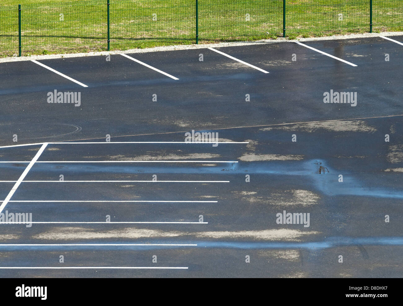 Empty wet parking places and grass Stock Photo - Alamy