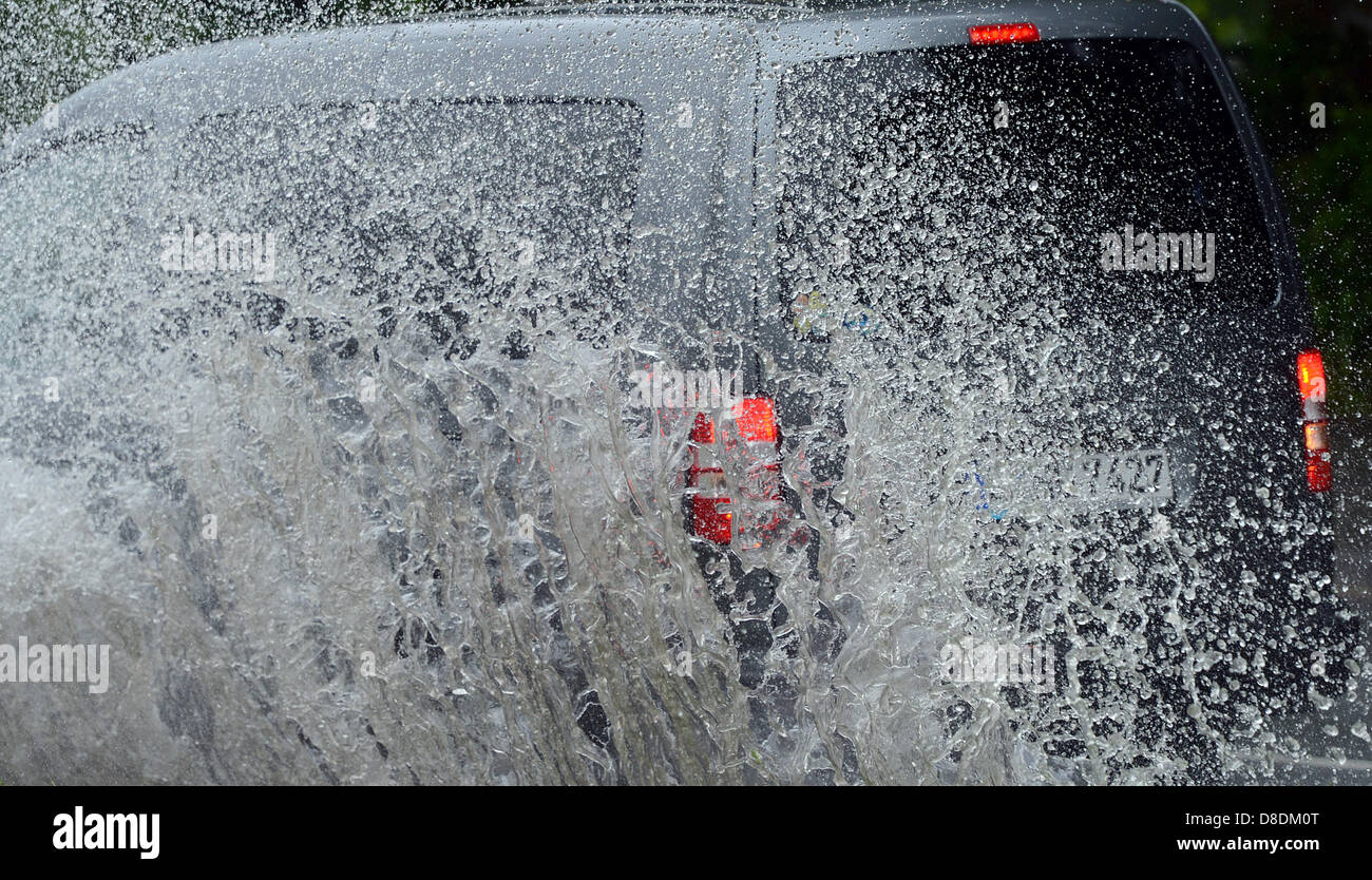A car drives through a large puddle on a street in Leipzig, Germany, 26 ...