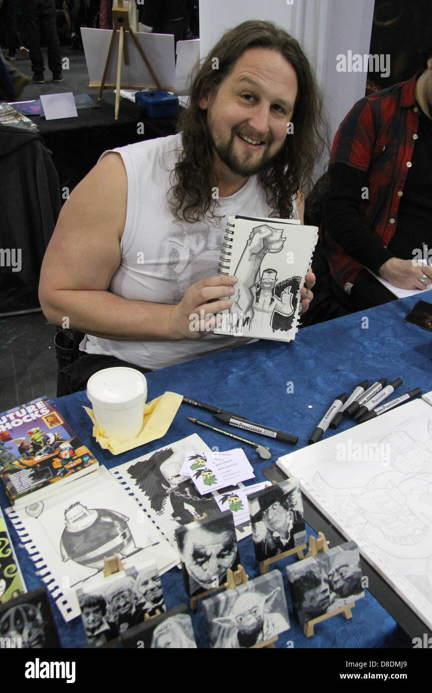 Artist and author Grant Perkins poses with one of his artwork at the ...