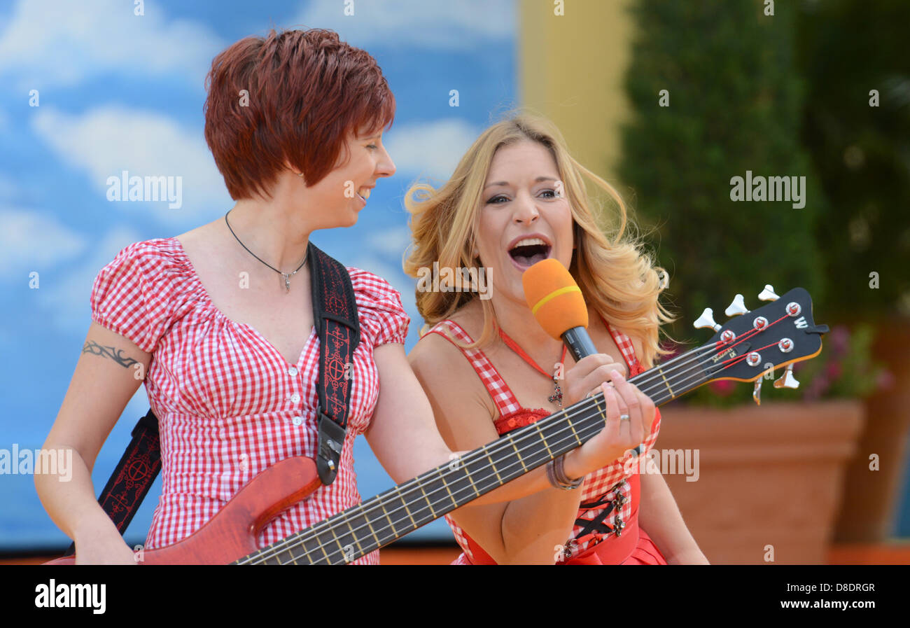 Singer Stefanie Hertel (R) performs on stage during the ARD music show ...
