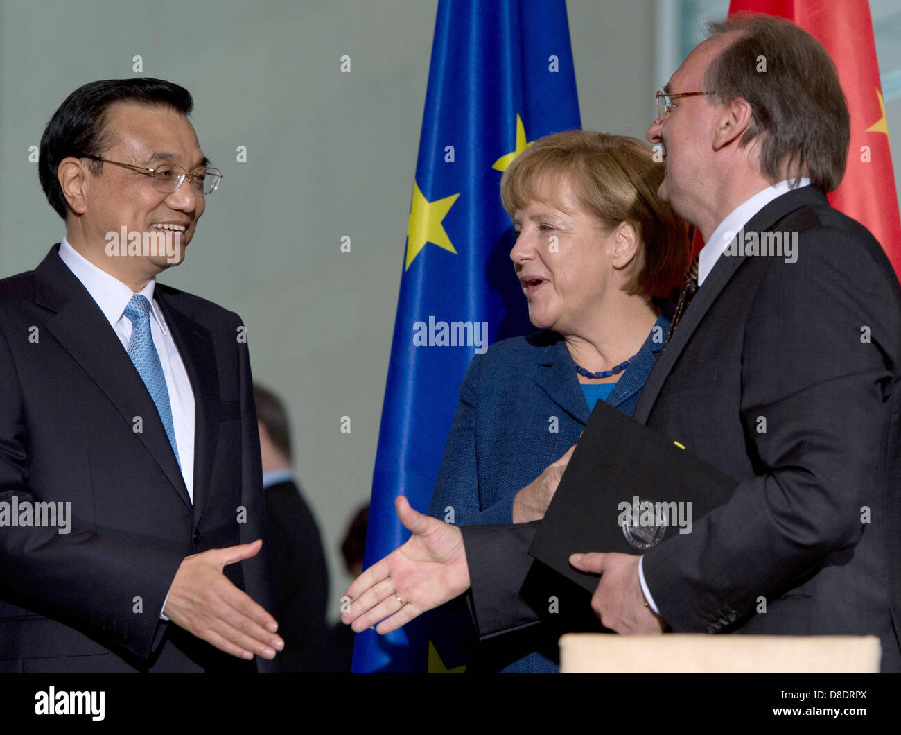 German Chancellor Angela Merkel (C) and new Premier of China Li Keqiang ...