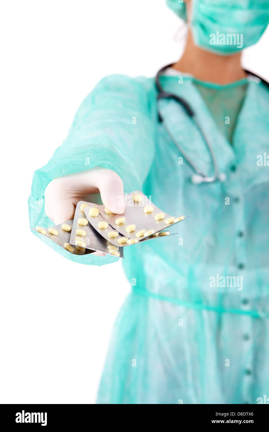 Nurse holding pills, isolated over white Stock Photo - Alamy