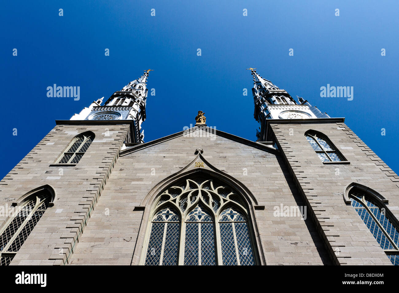 Symmetrical view looking up at exterior of Notre Dame Cathedral ...