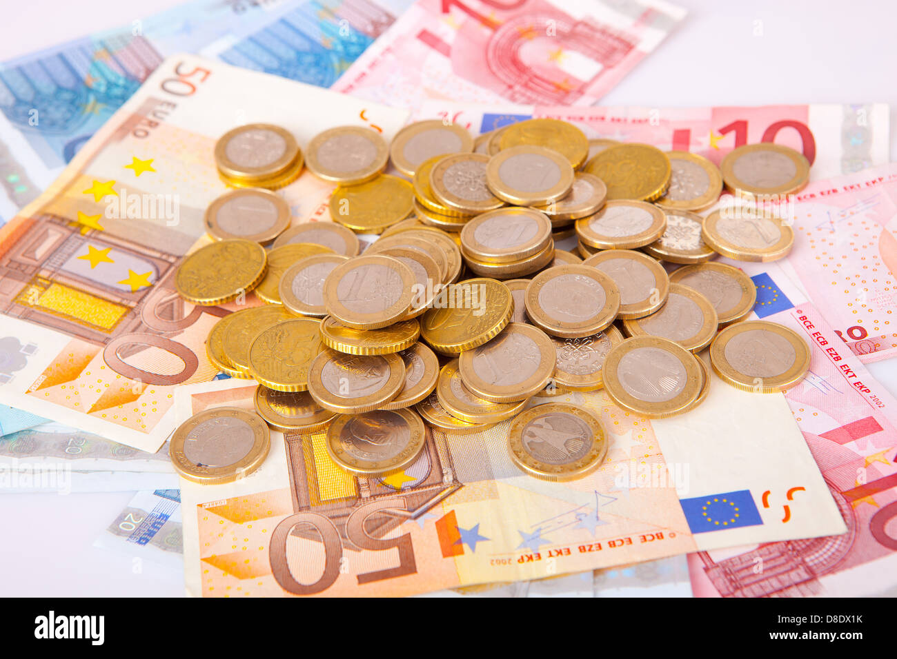 Pile of notes and coins Stock Photo - Alamy