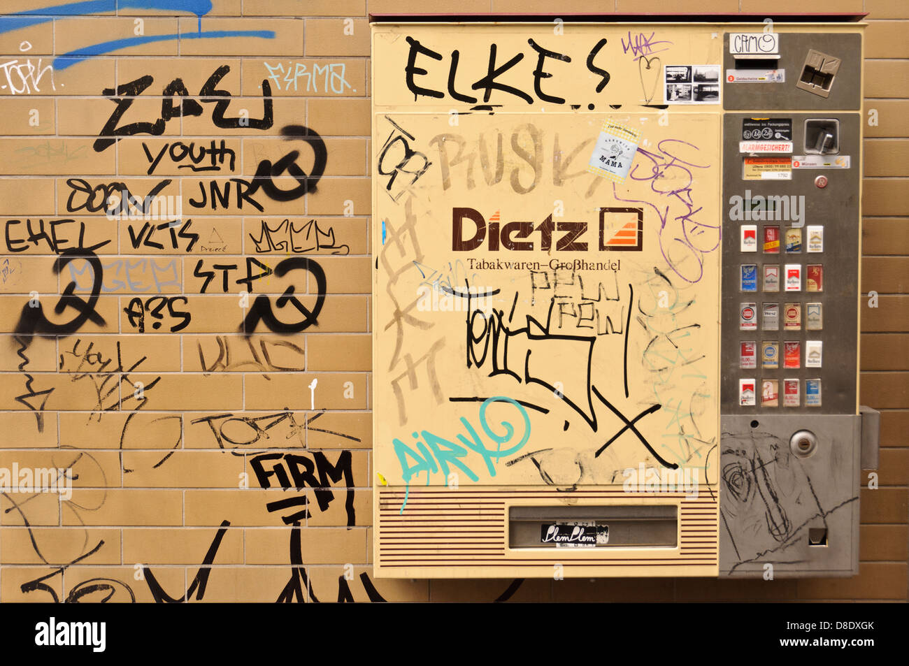 Cigarette slot machine on a brick wall with graffiti showing vandalism ...
