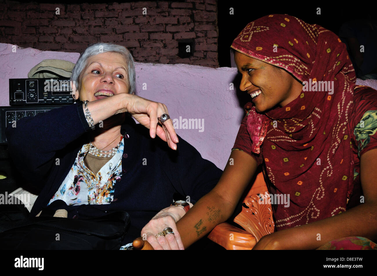 Italian lady with Indian girl laughing Stock Photo - Alamy