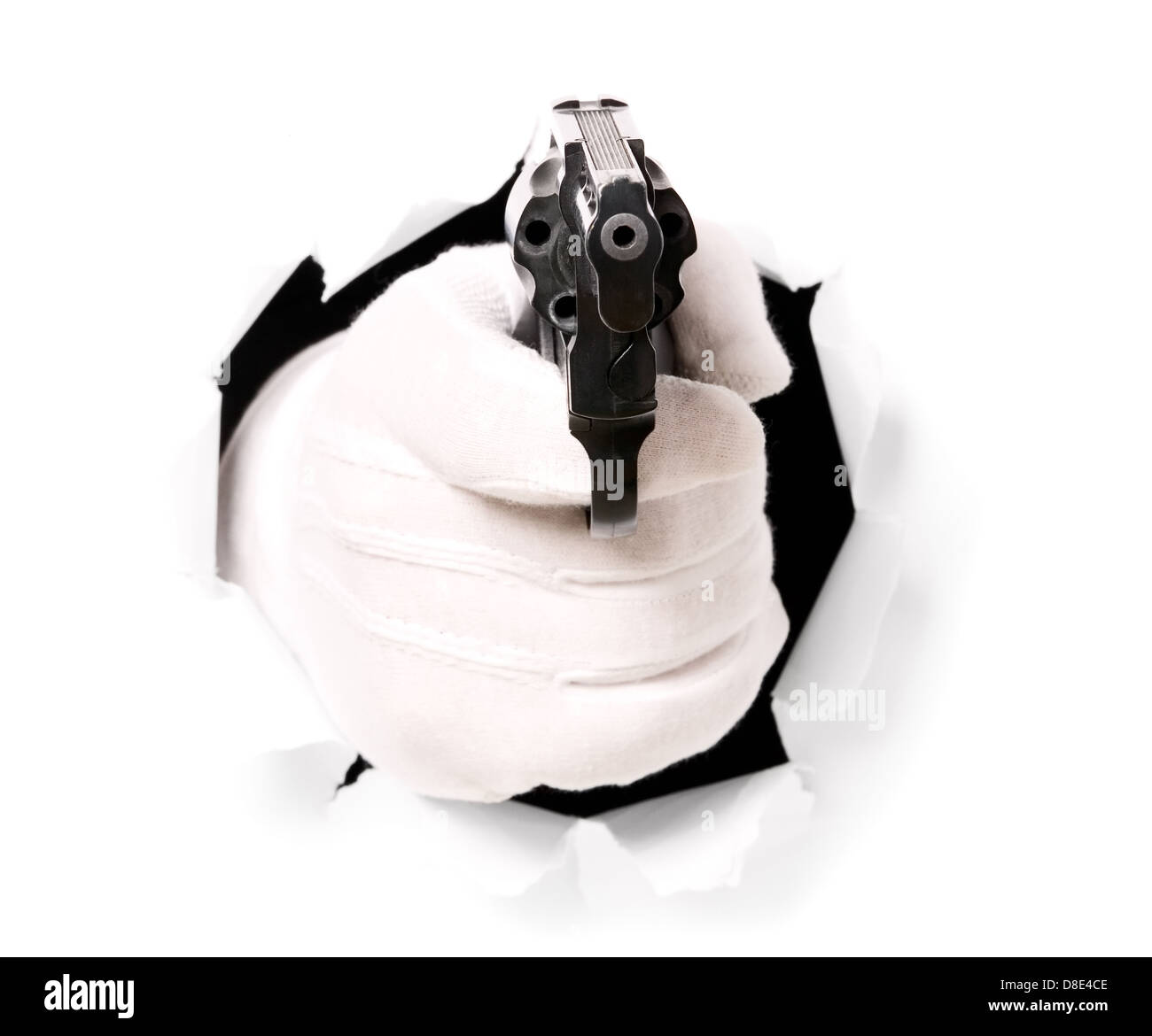 Man with gloves is holding gun through a hole in white paper Stock ...