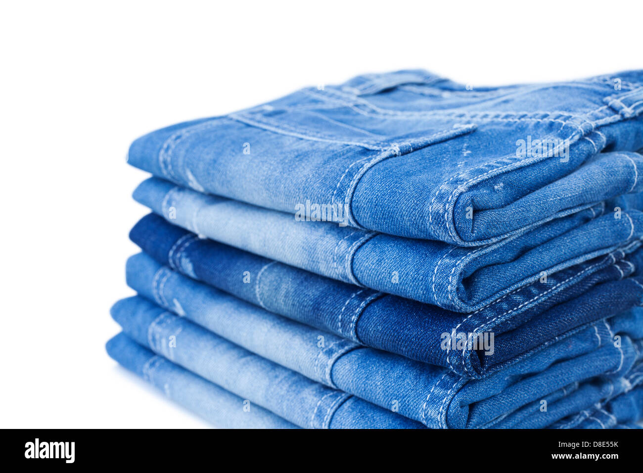 Stack of blue jeans isolated on white background Stock Photo - Alamy