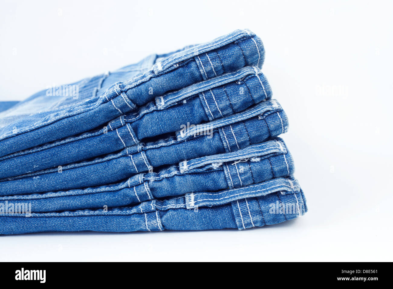 Stack of blue jeans isolated on white background Stock Photo - Alamy
