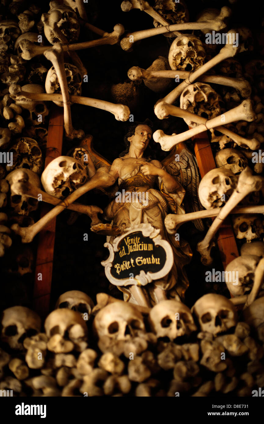 A saint statue surrounded by human Skulls and bones in the Skull Chapel ...
