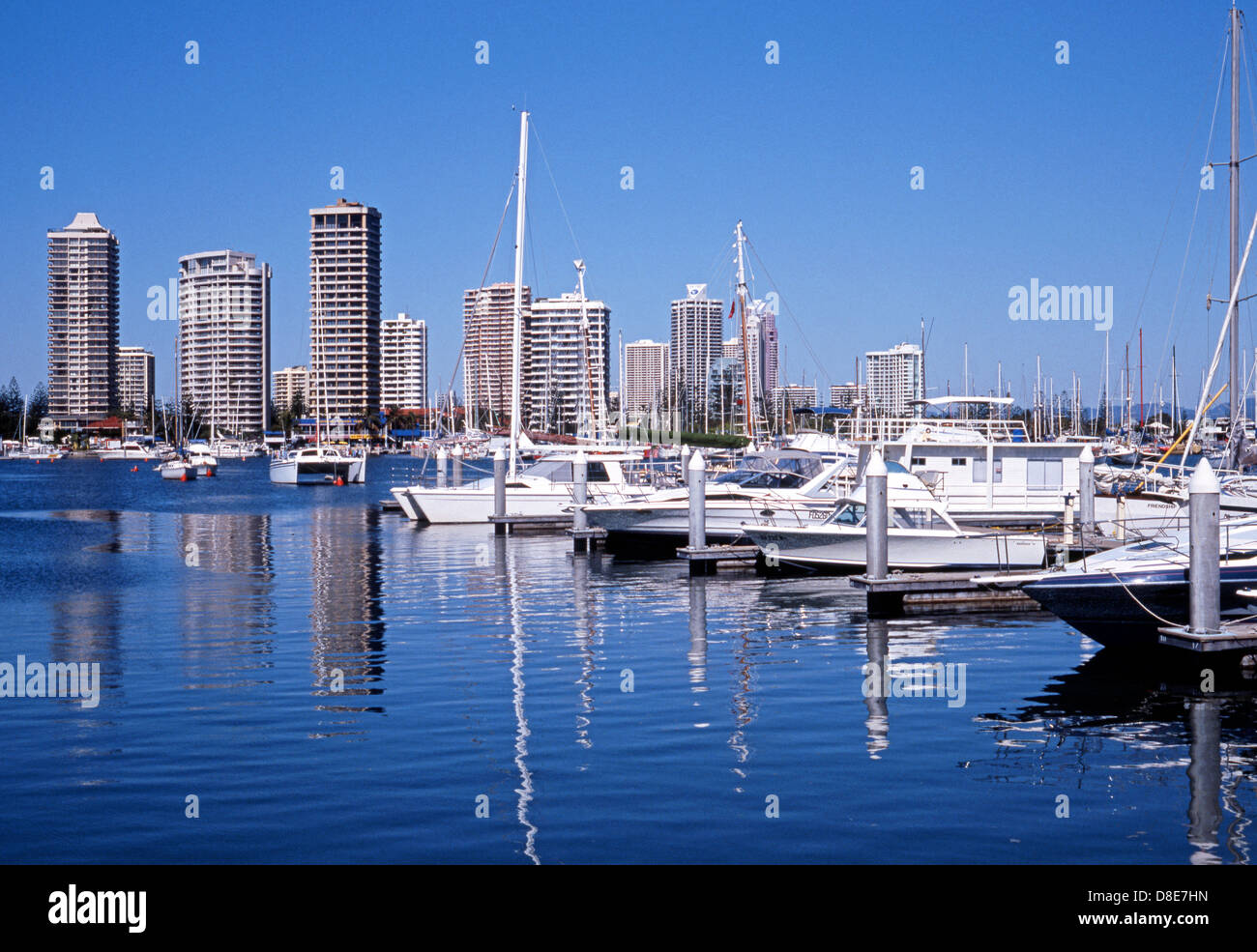 Pleasure boats along jetty with apartments to rear, Surfers Paradise ...