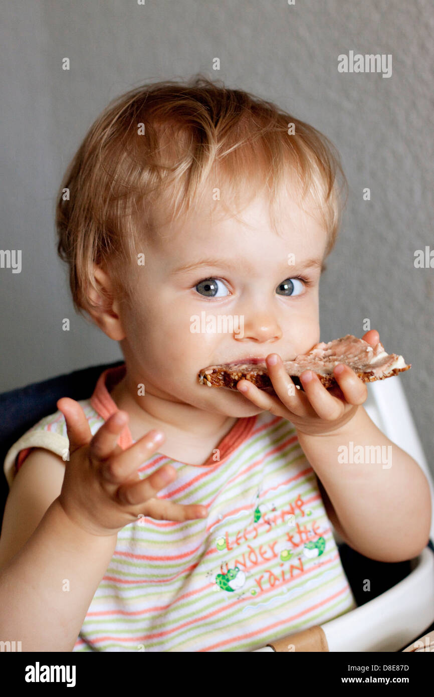 Toddler eating, portrait Stock Photo - Alamy