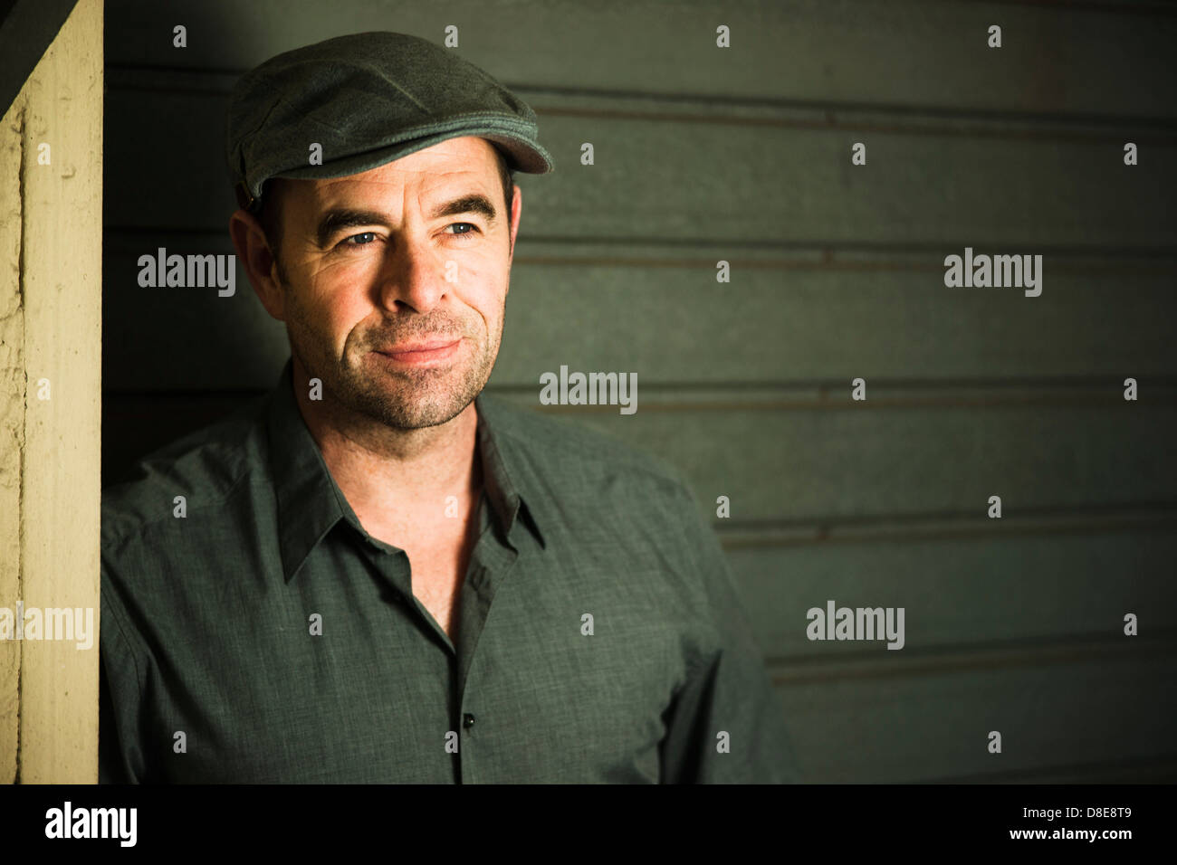 Man with cap thinking Stock Photo - Alamy