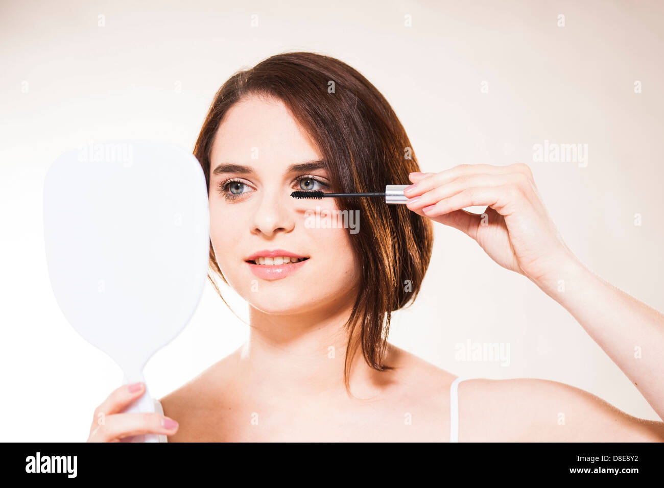 Young woman applying make up Stock Photo - Alamy