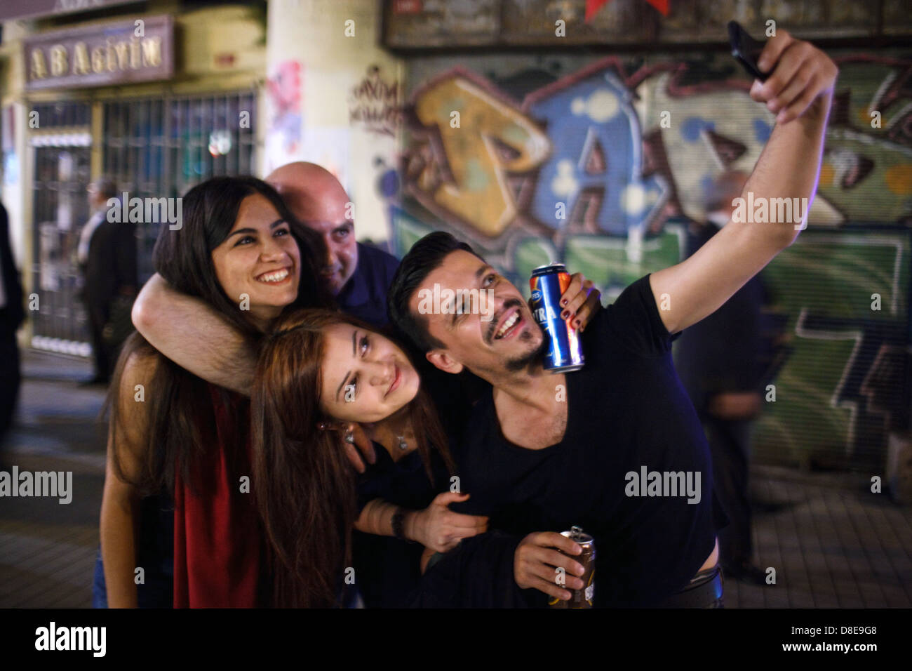 A group of young Turkish people taking a photo of themselves using a ...