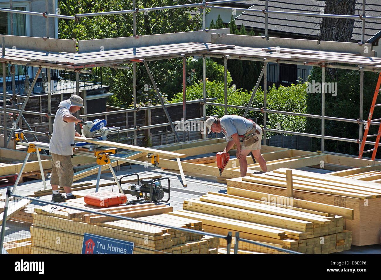 Two carpenters working on a new house Stock Photo - Alamy